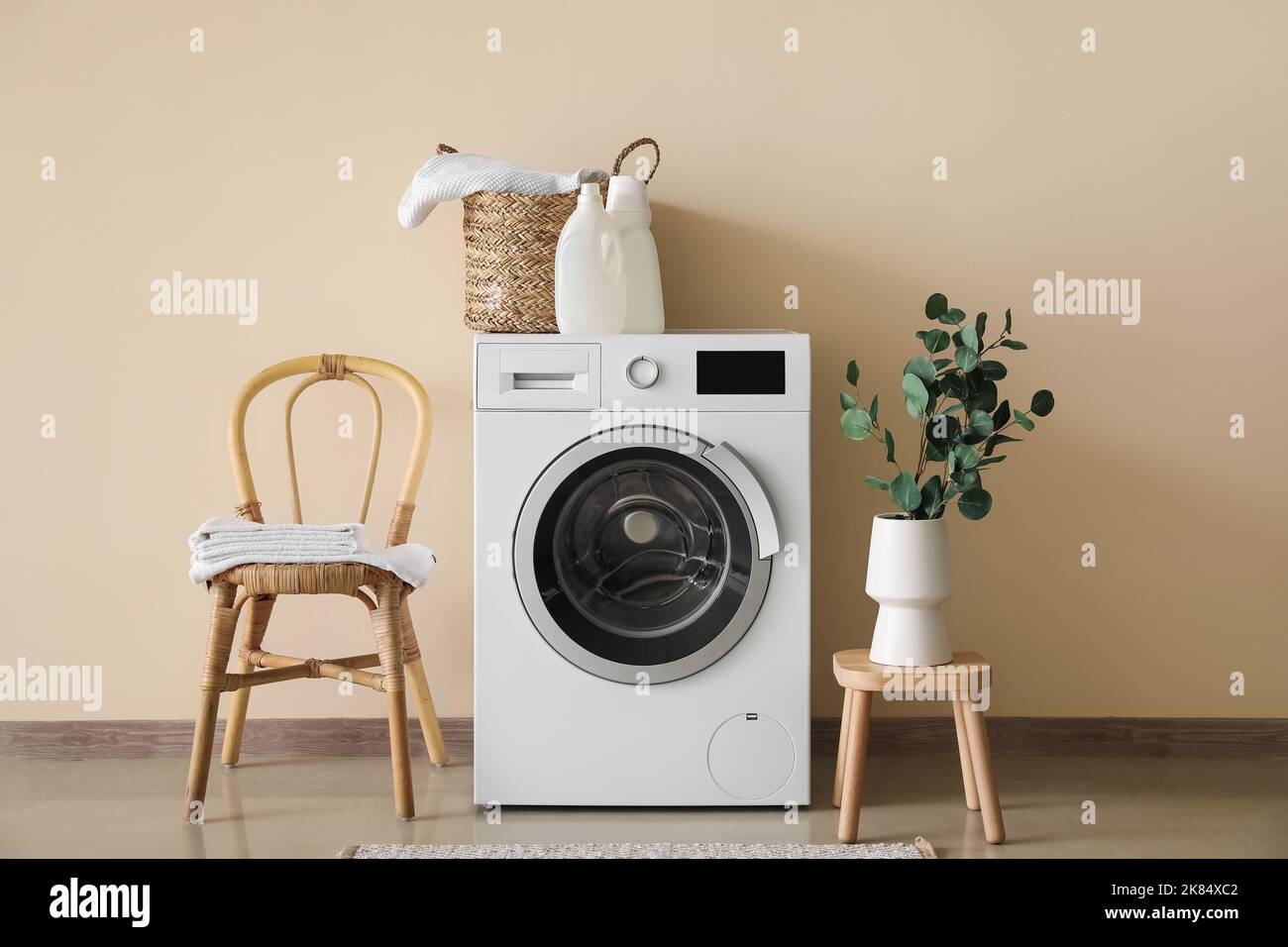 Interior of laundry room with washing machine, chair and stool Stock ...