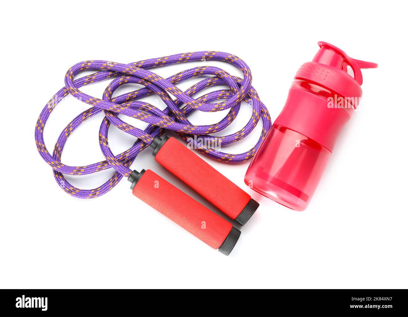 Skipping rope and bottle of water on white background Stock Photo - Alamy