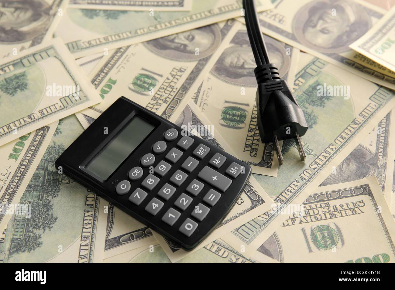 Calculator and plug on dollar banknotes. Heating season concept Stock ...