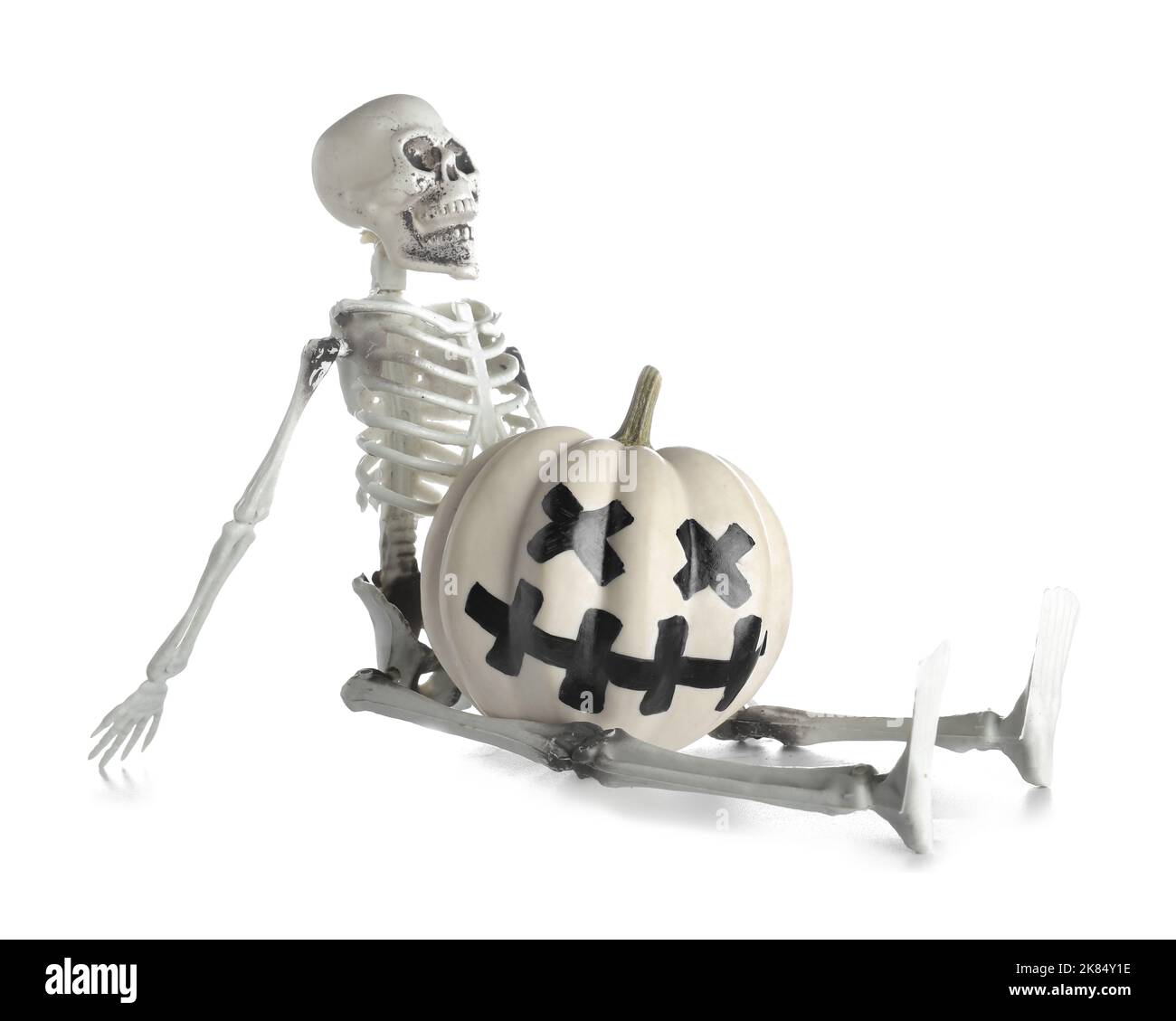 Halloween pumpkin with drawn face and skeleton on white background ...
