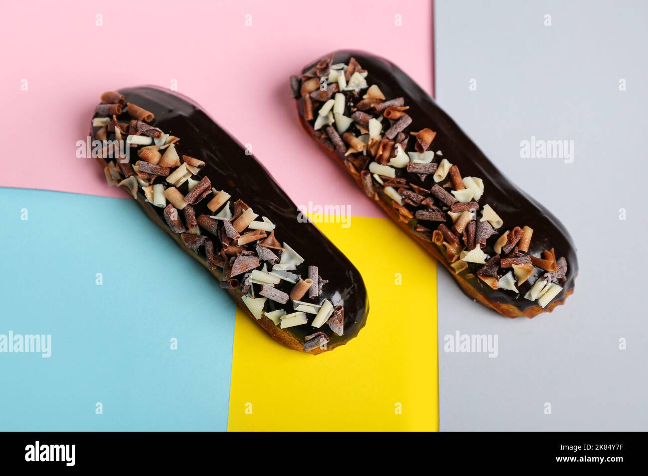 Delicious chocolate eclairs on color background Stock Photo - Alamy