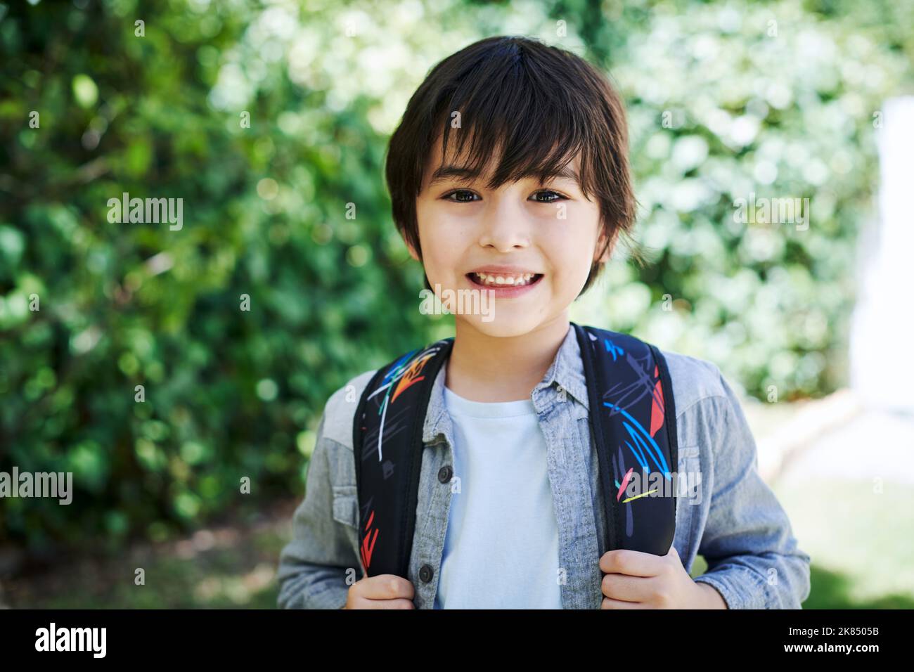 Off to school I go. a little boy wearing a backpack in nature Stock ...
