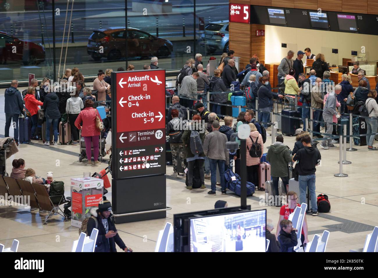 Berlin, Germany. 21st Oct, 2022. Travelers stand at check-in desks in ...