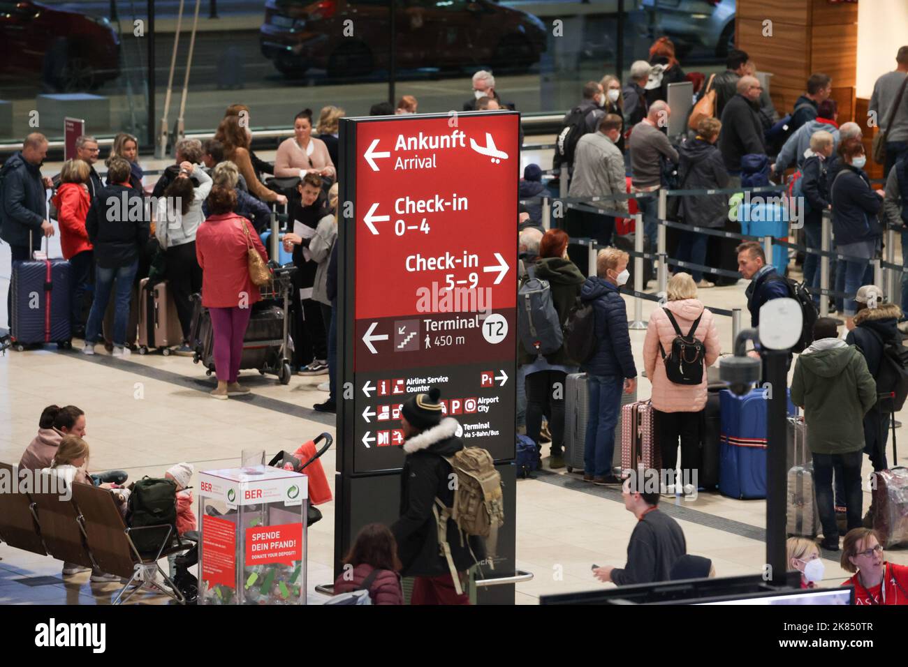 Berlin, Germany. 21st Oct, 2022. Travelers stand at check-in desks in ...