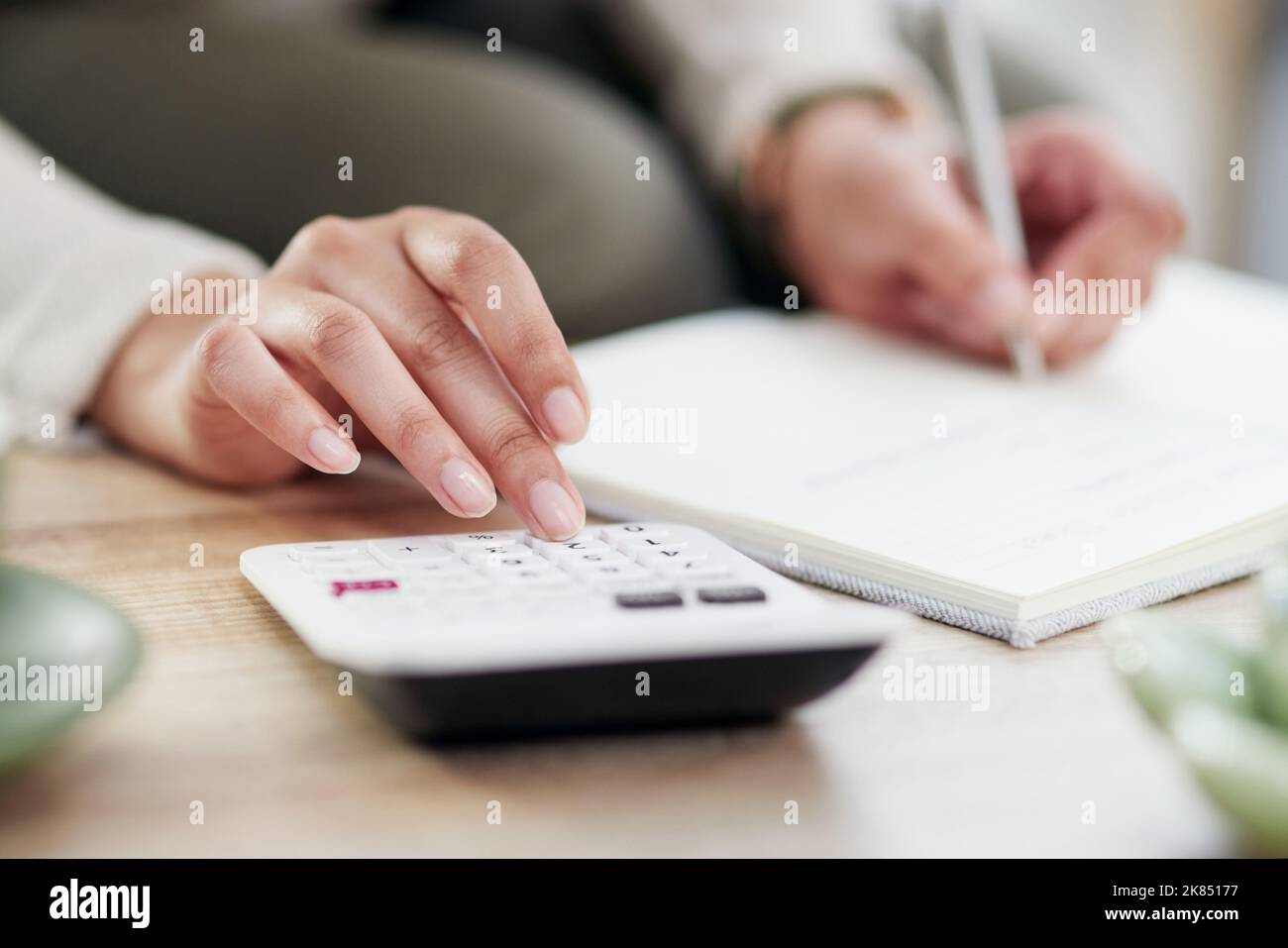 Adding it all up. Closeup shot of an unrecognisable businesswoman ...