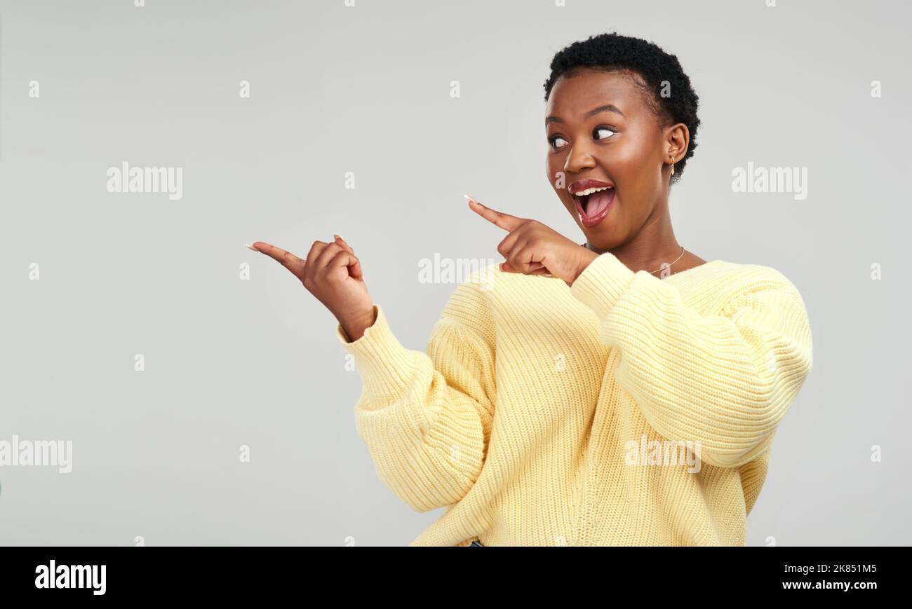 All this could be yours. a young woman pointing at copy-space while ...