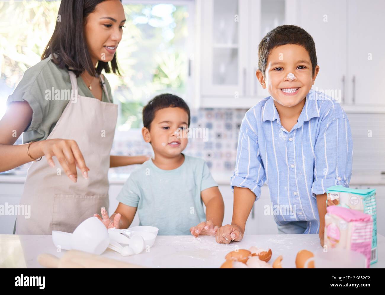 Cooking, help and mother with children in kitchen for learning ...