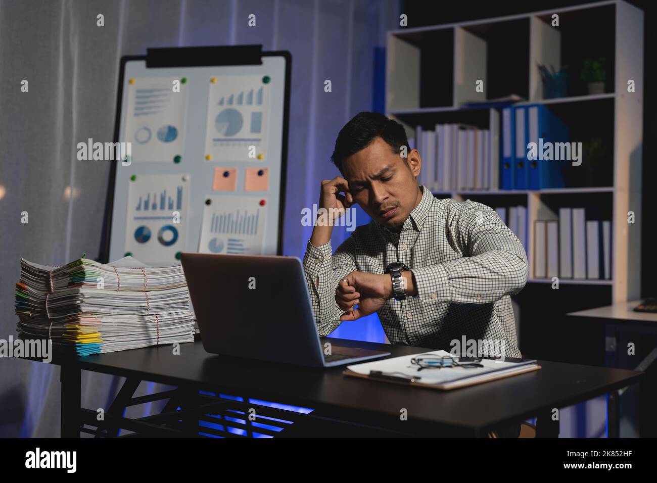 Tired and worried business man at workplace in office looking on his ...