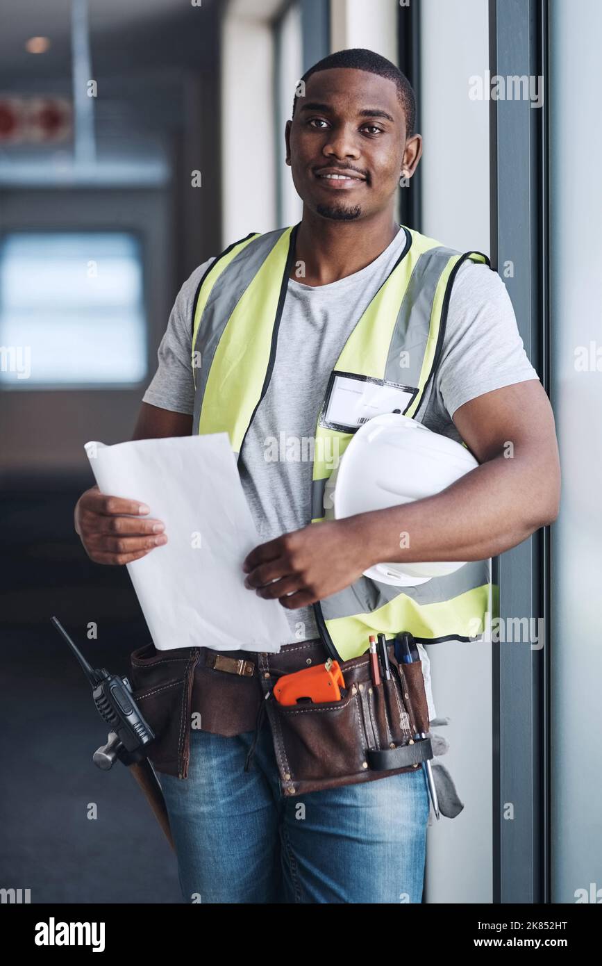 The design rests in my hands now. a handsome young contractor standing ...