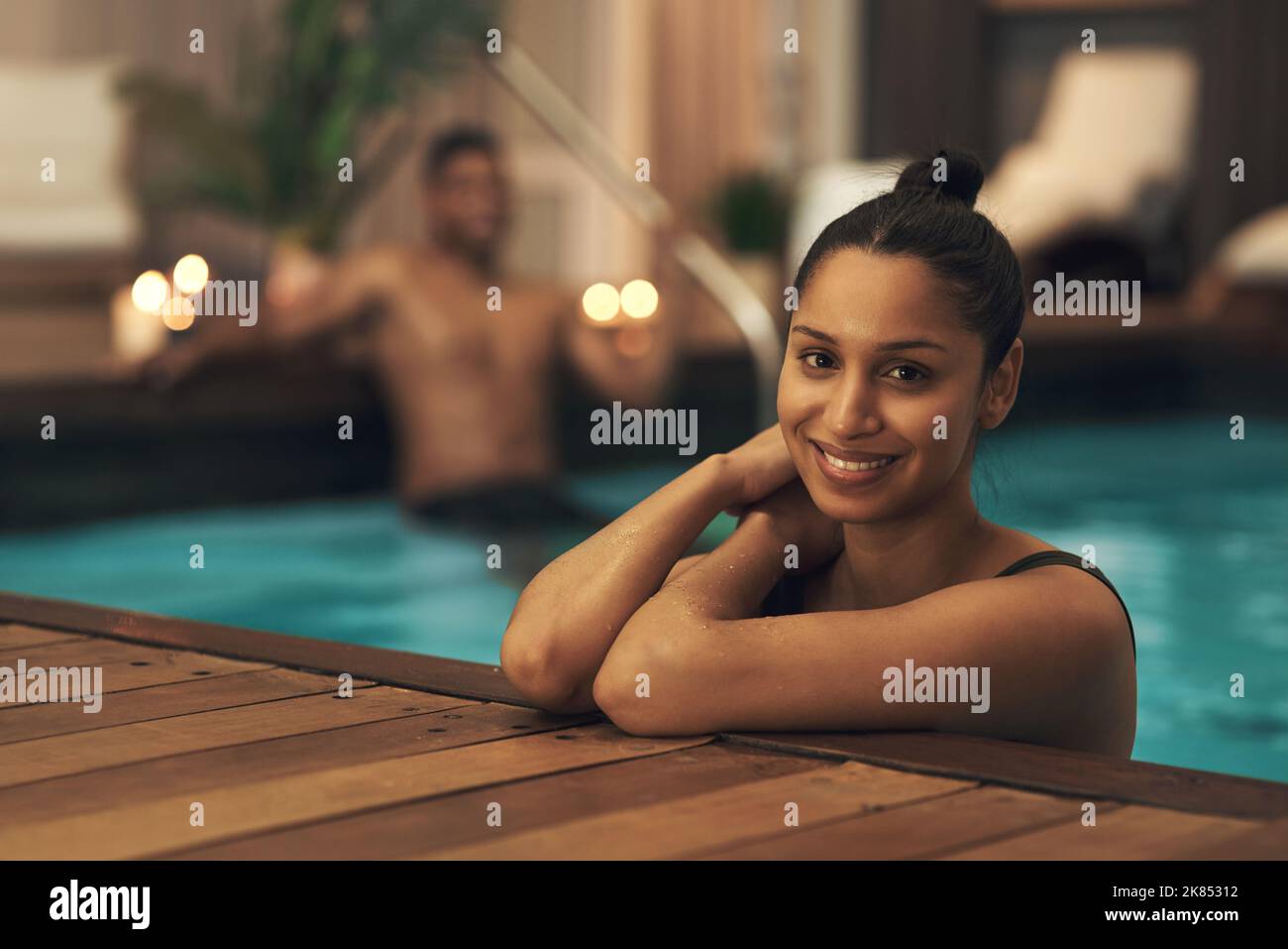 The pool is my favourite place to relax here. a young woman relaxing in ...