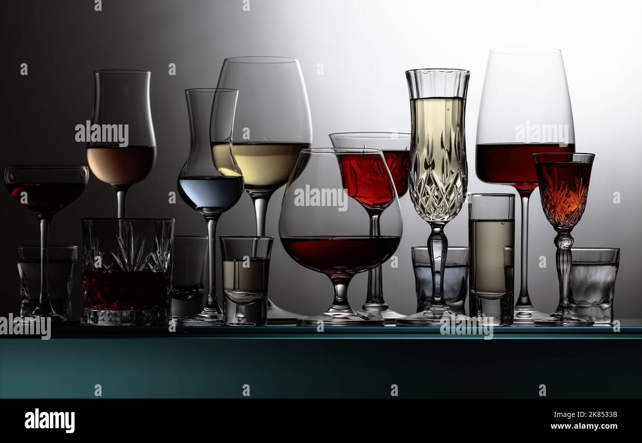 Various alcoholic drinks in the bar on glass shelves Stock Photo - Alamy