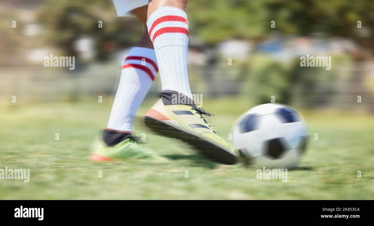 Soccer, grass and legs kick a football in a training game, practice ...