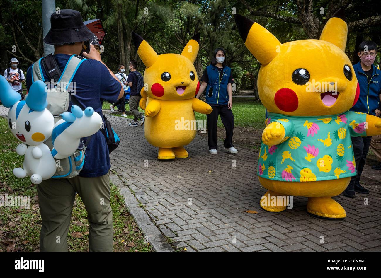 Taipei. 21st Oct, 2022. Two Pikachu mascots walk through the park as ...