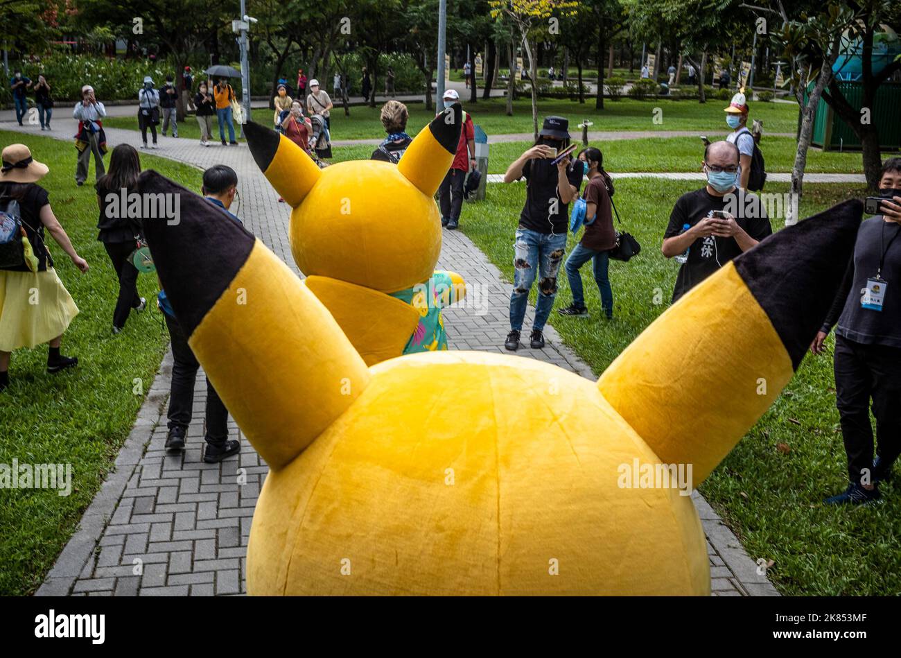 Taipei. 21st Oct, 2022. Two Pikachu mascots walk through the park as ...