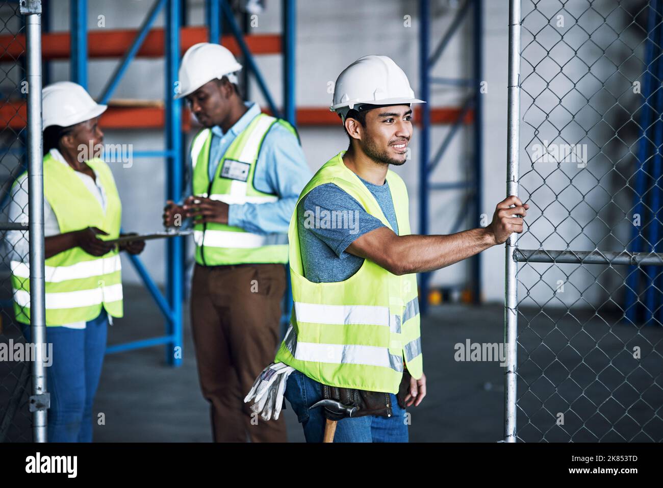 Back in business and back in action. a young builder opening the gates ...