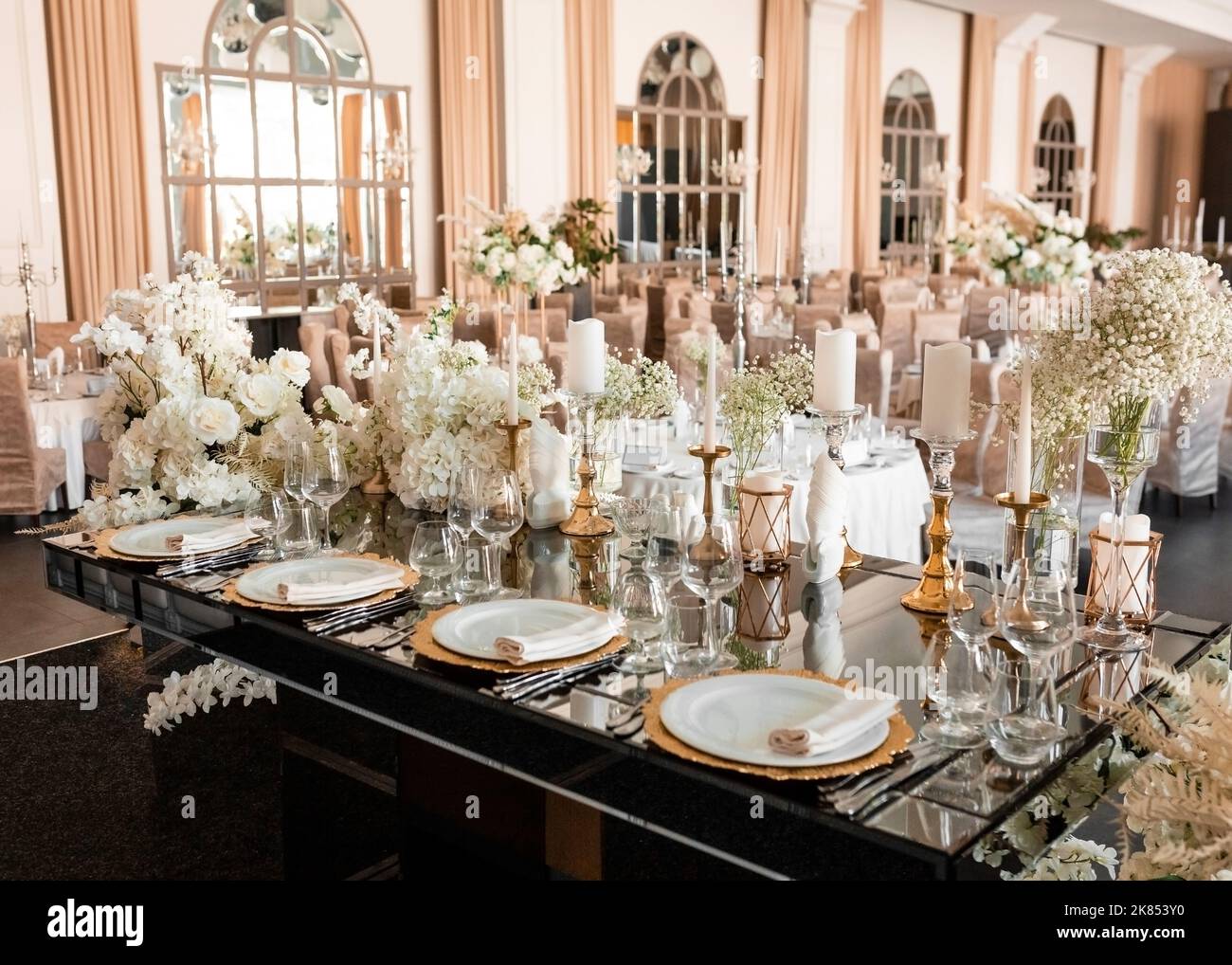 Side view of nicely decorated wedding banquet table with floral ...