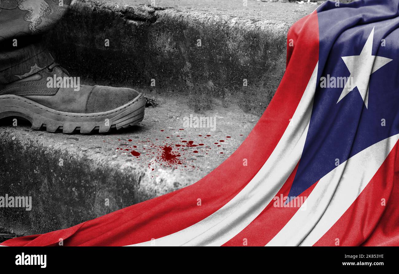 The leg of the military stands on the step next to the flag of Puerto ...