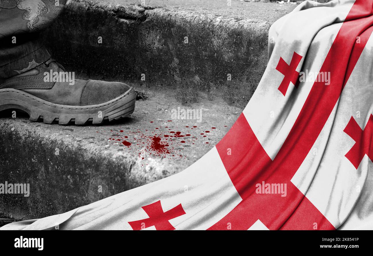 The leg of the military stands on the step next to the flag of Georgia ...