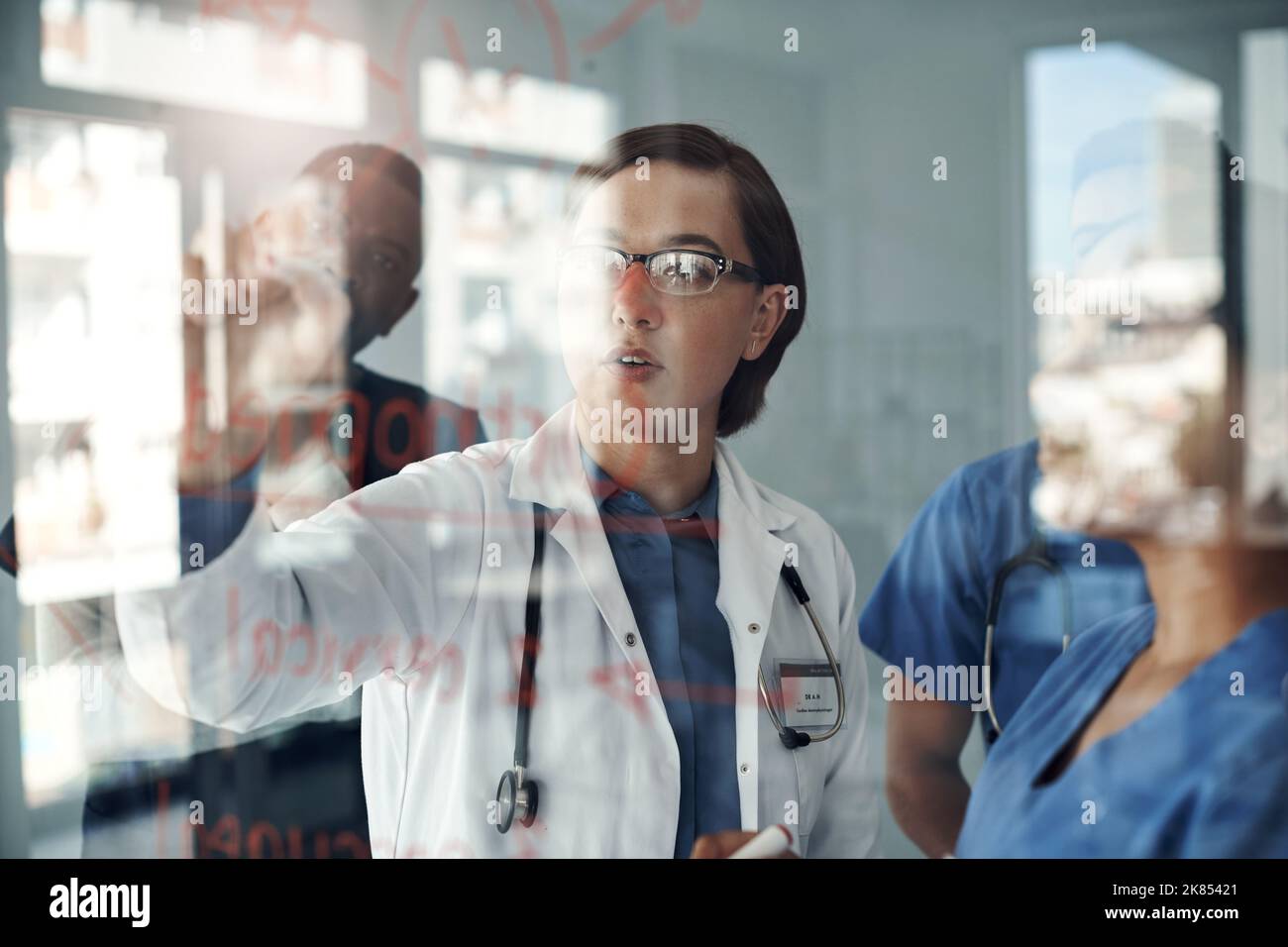 Knowledge is power. Shot a group of doctors discussing formulas in the ... Knowledge is power. Shot a group of doctors discussing formulas in the ...