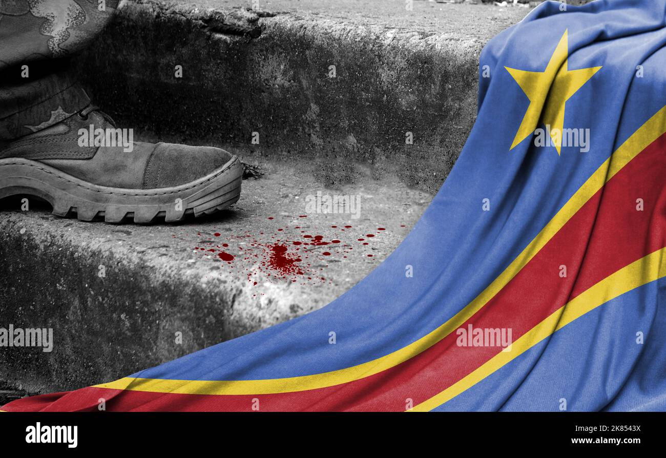 The leg of the military stands on the step next to the flag of Congo ...