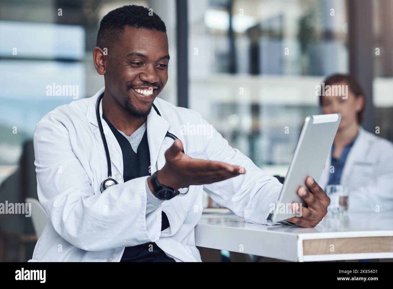 Hi how are you. a young male doctor taking a break and using his ...