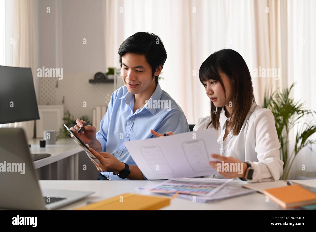 Web developer team collaborating and developing template layout for ... Web developer team collaborating and developing template layout for ...