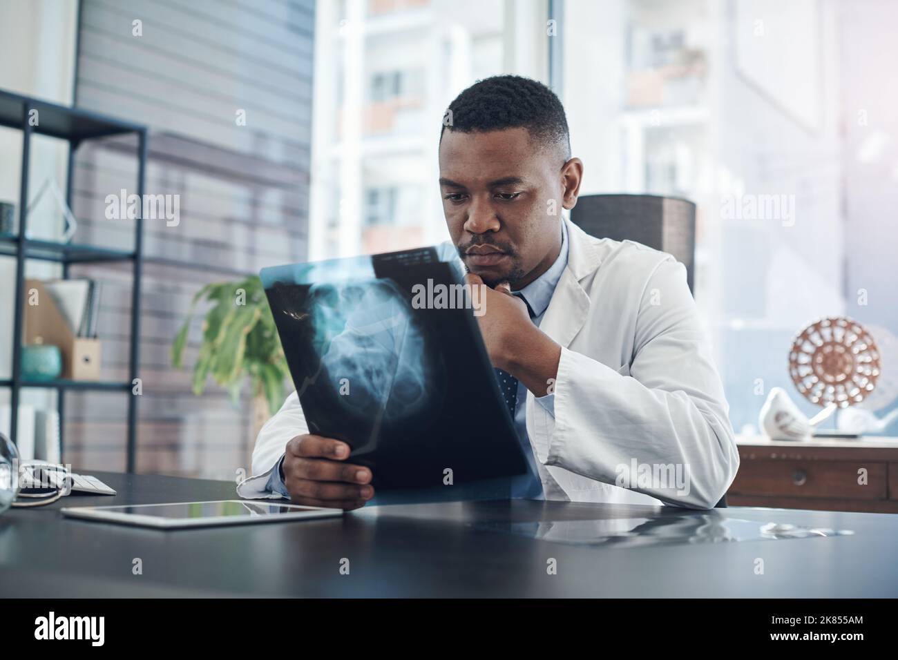 I need to put some thought into this. a young doctor examining an x-ray ...