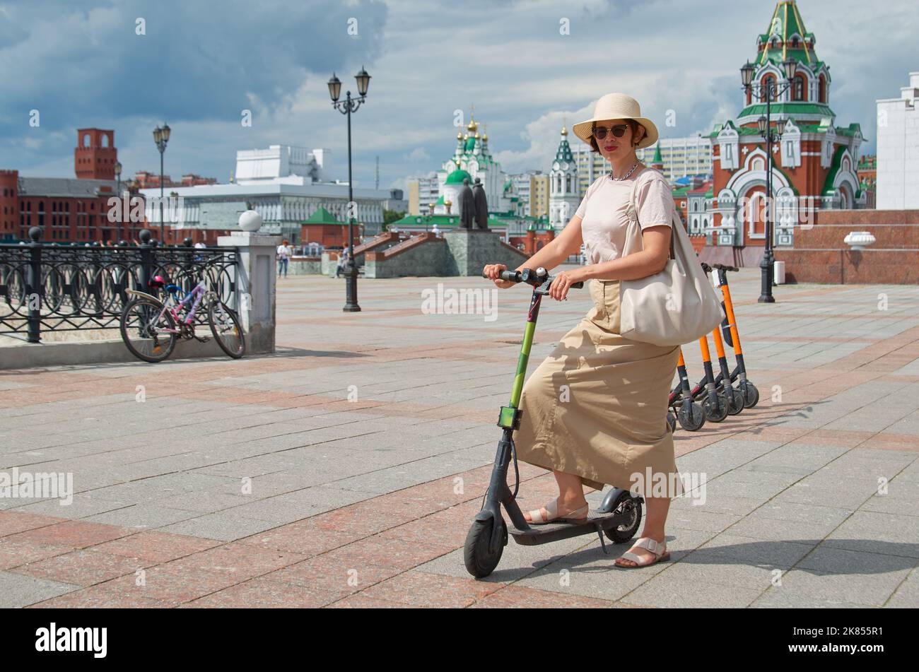 Pretty happy positive girl wear casual outfit ride electric scooter in ...