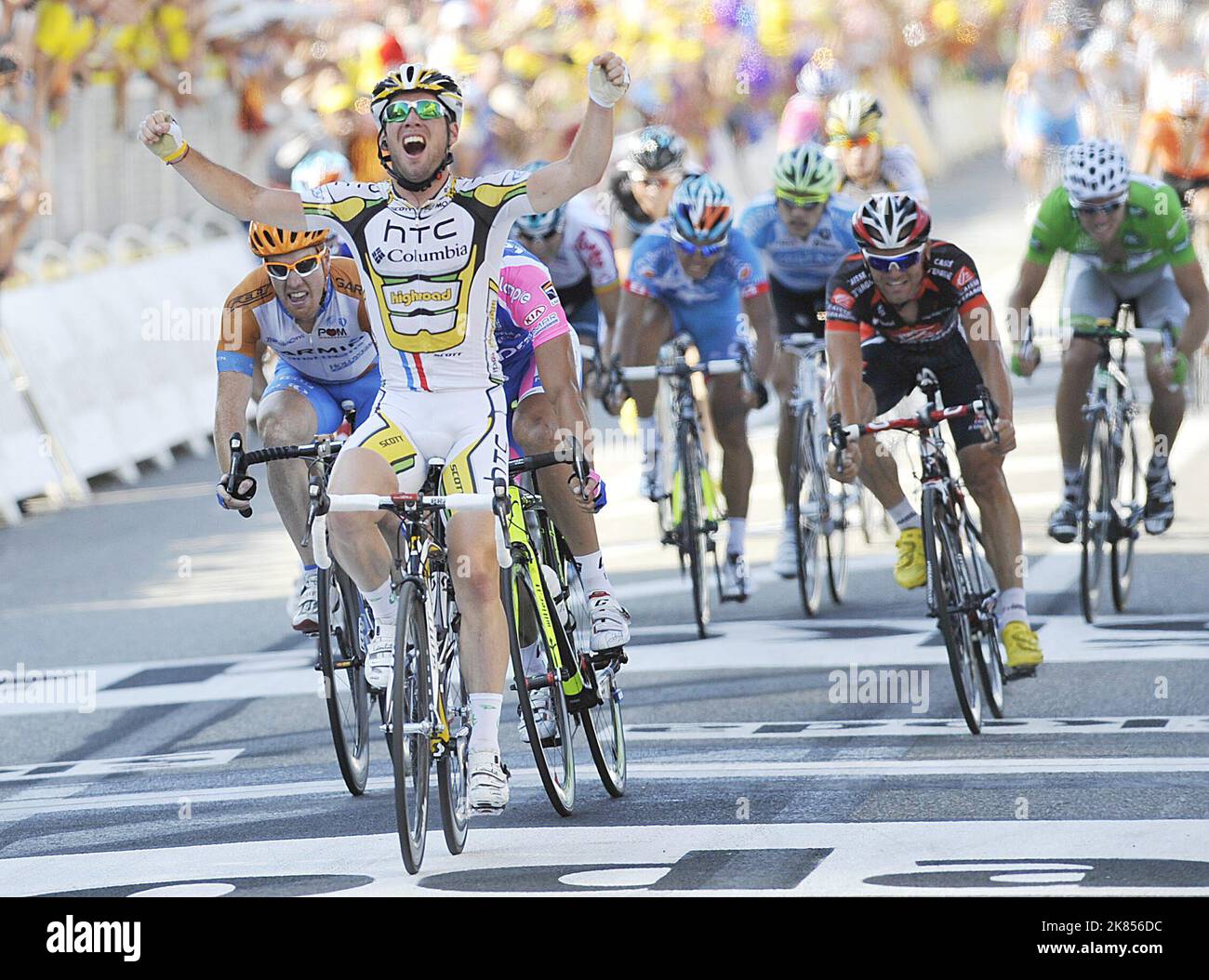 HTC Columbia's Mark Cavendish (L) crosses the finish line in first ...