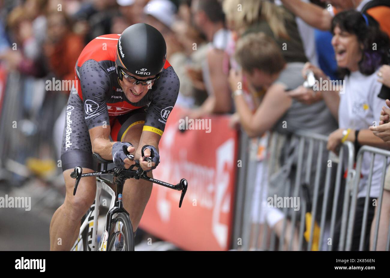 Lance Armstrong races to the finish line in the first day's time trial ...