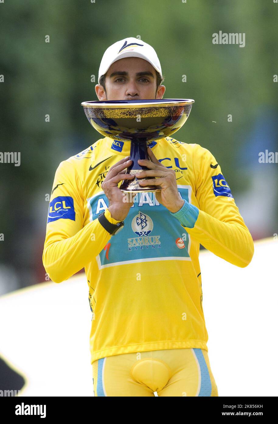 Astana's Alberto Contador celebrates with the trophy after winning the ...