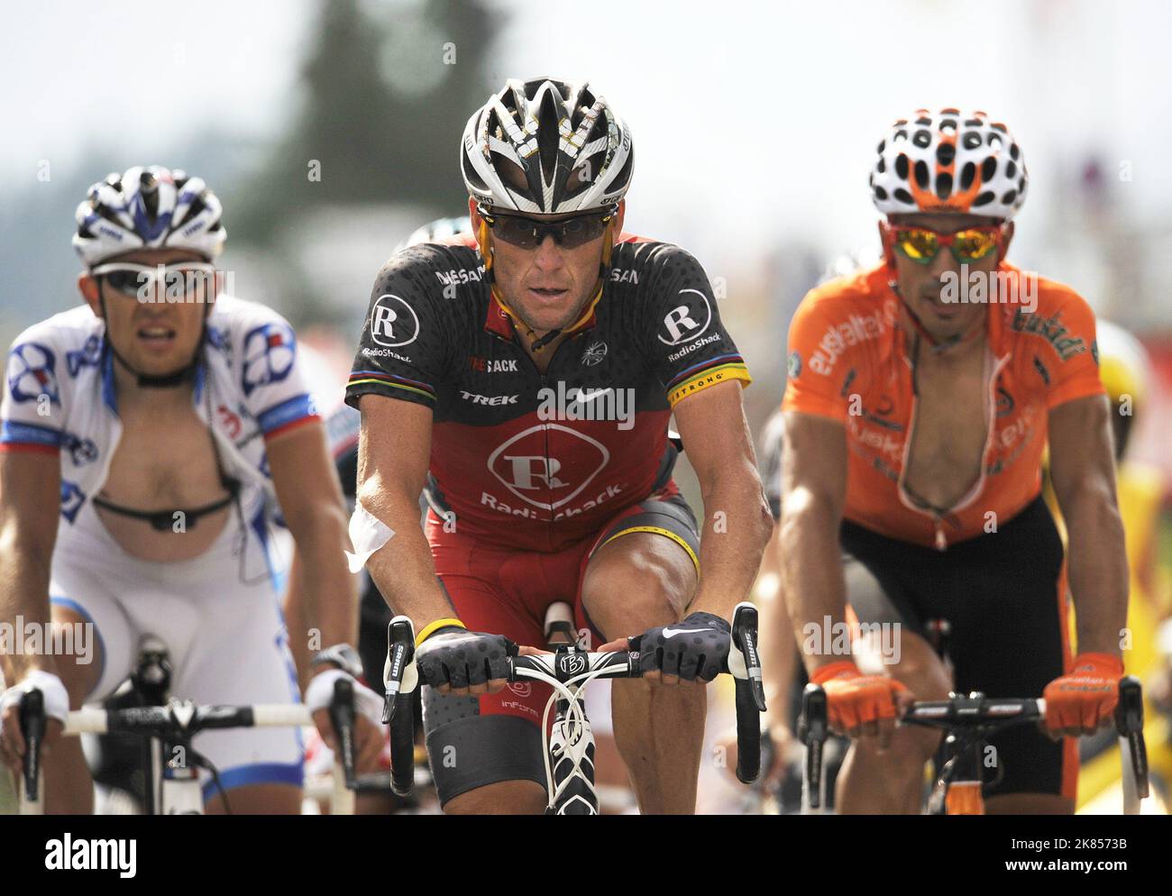 Team RadioShack's Lance Armstrong (C) crosses the finish line in 61st ...