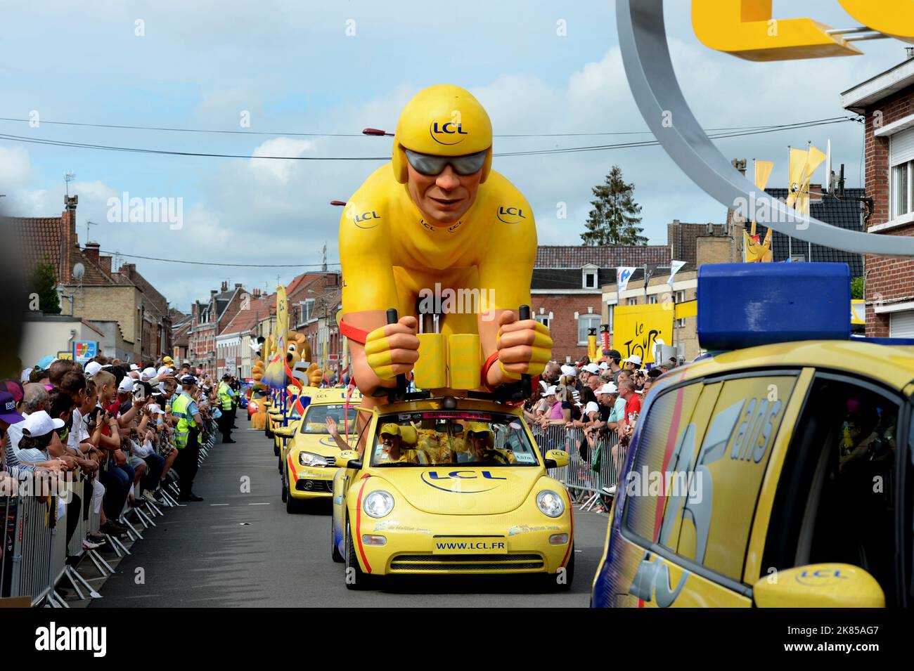 The caravan ride out of Orchies lead by a giant LCL cyclist float Stock ...