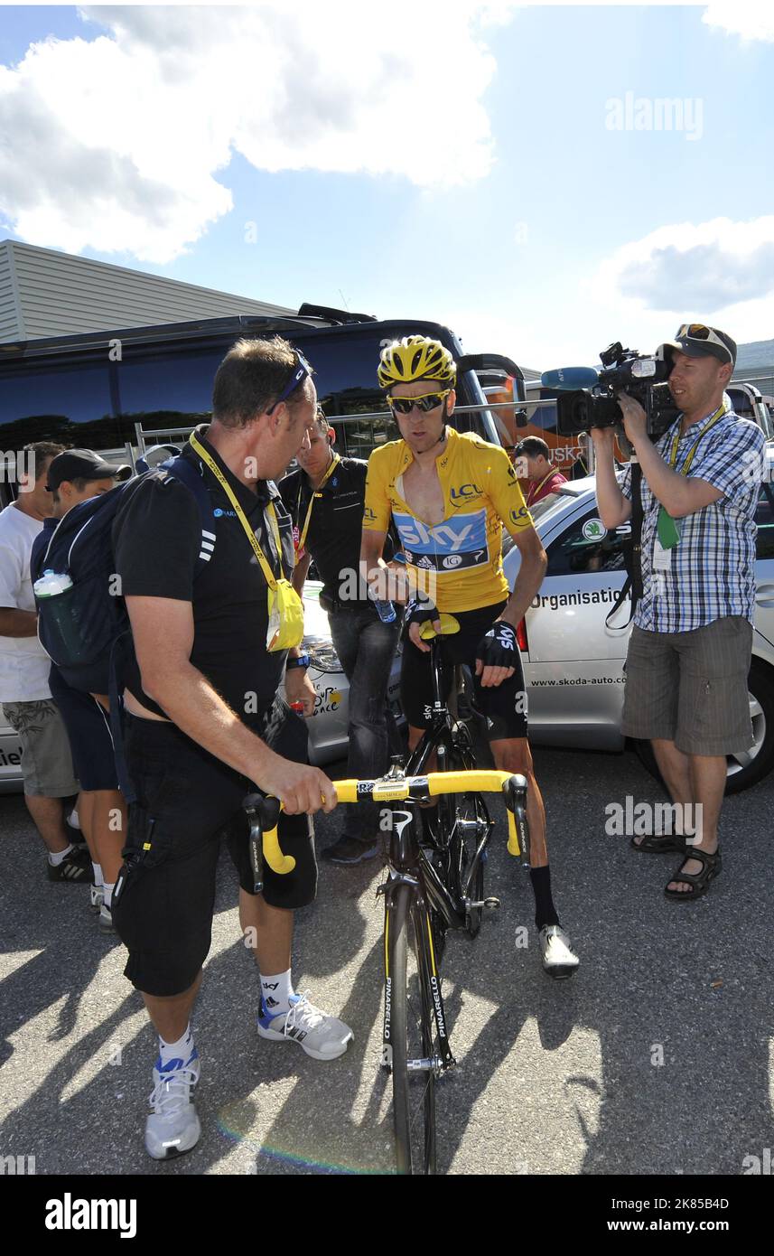 Bradley Wiggins of team Sky Procycling walks back to the podium after ...