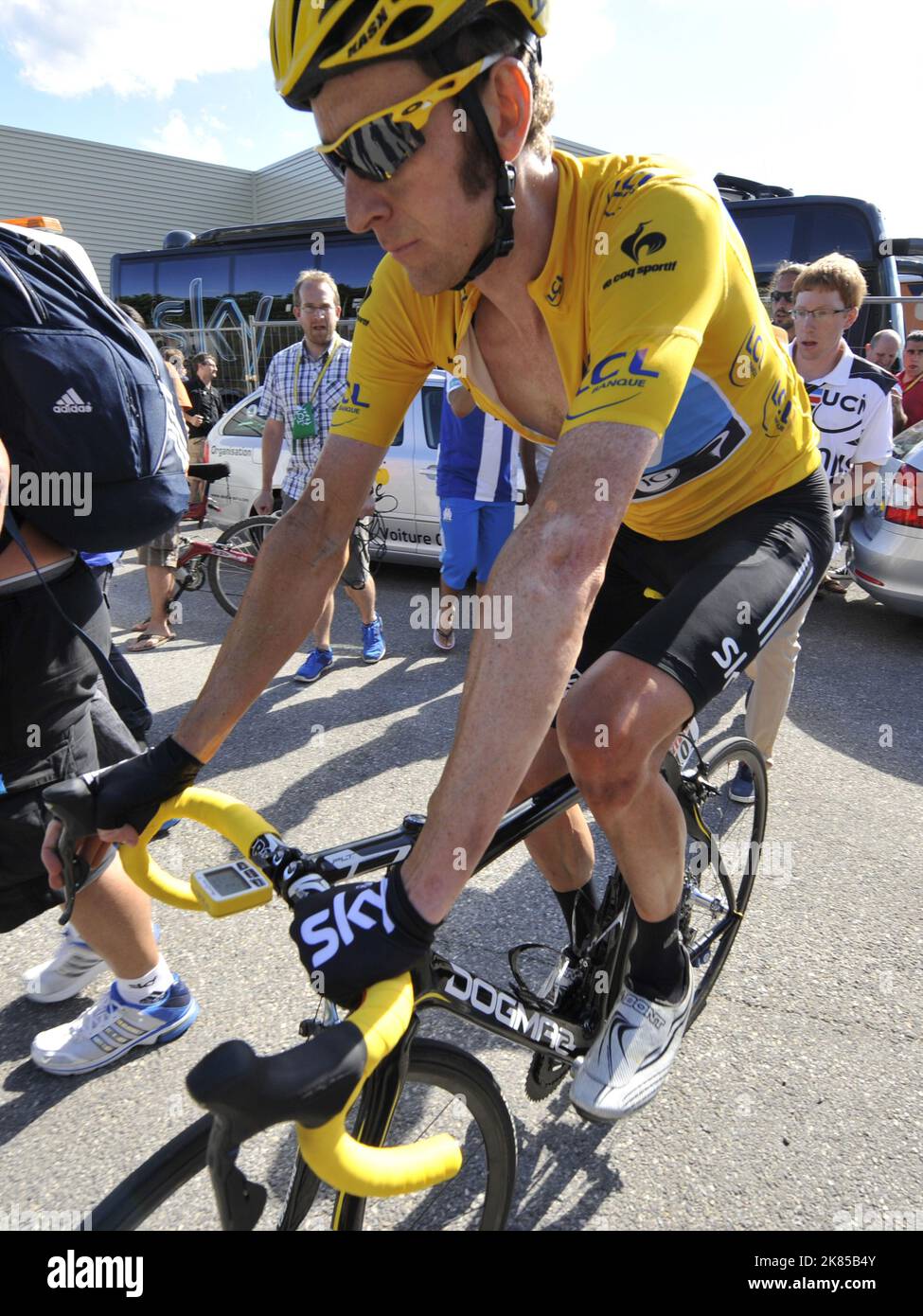 Bradley Wiggins of team Sky Procycling walks back to the podium after crossing the finish line ...