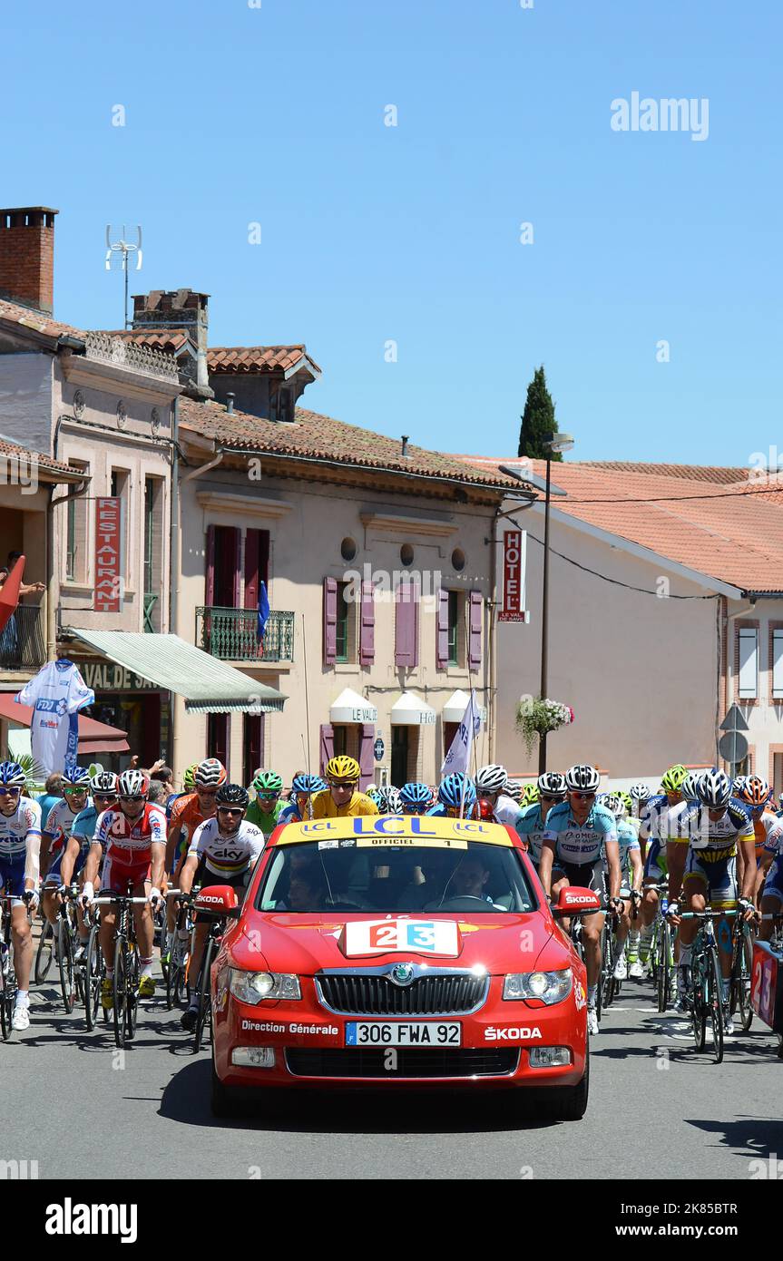 The peloton roll out at the start of the stage with the course director ...