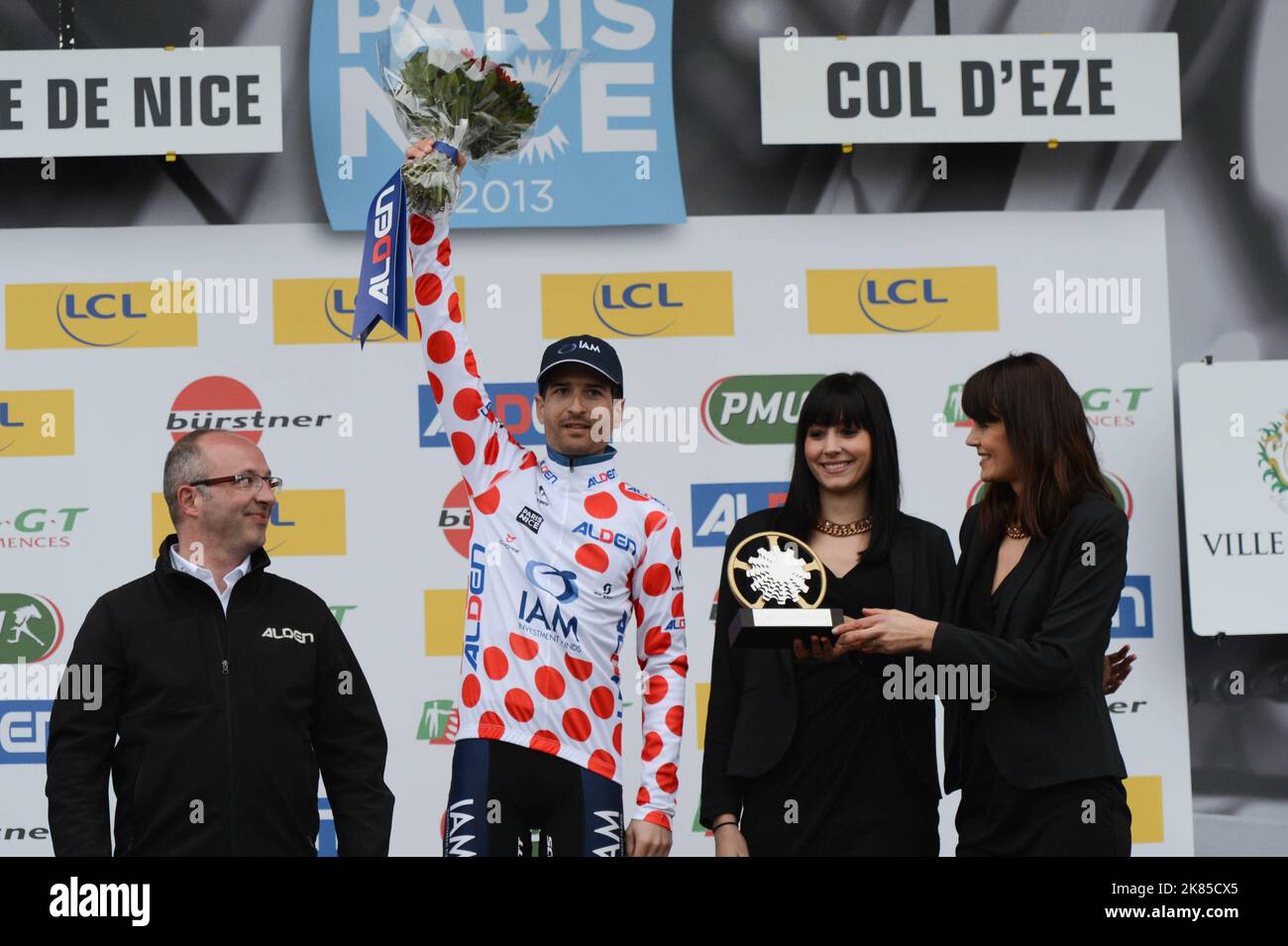 Andrew Talansky of team Garmin Sharp stands in the white jersey on the ...