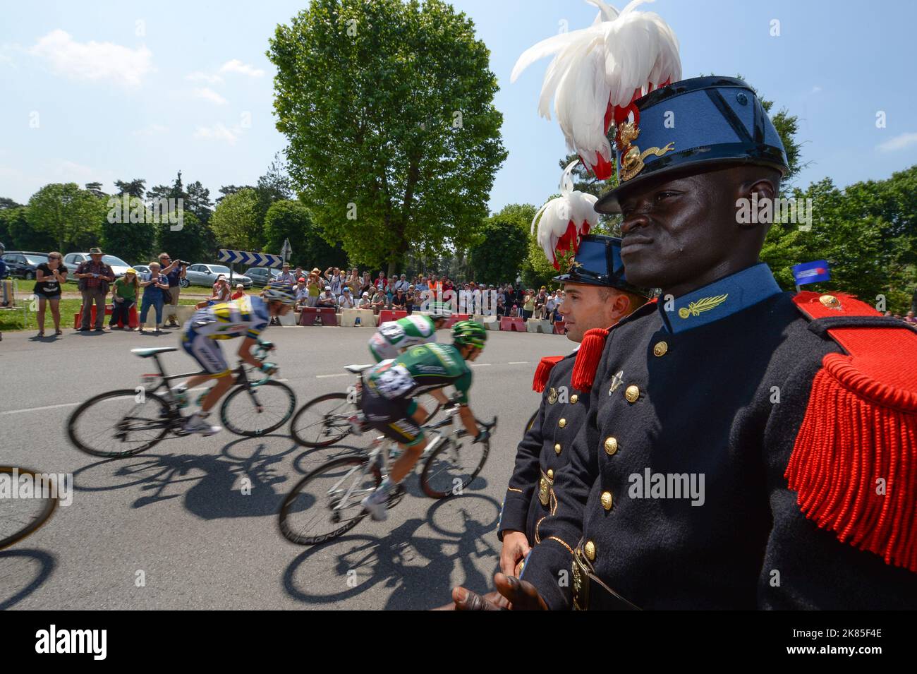 Soldiers from the French army stand and watch as the tour de france ...