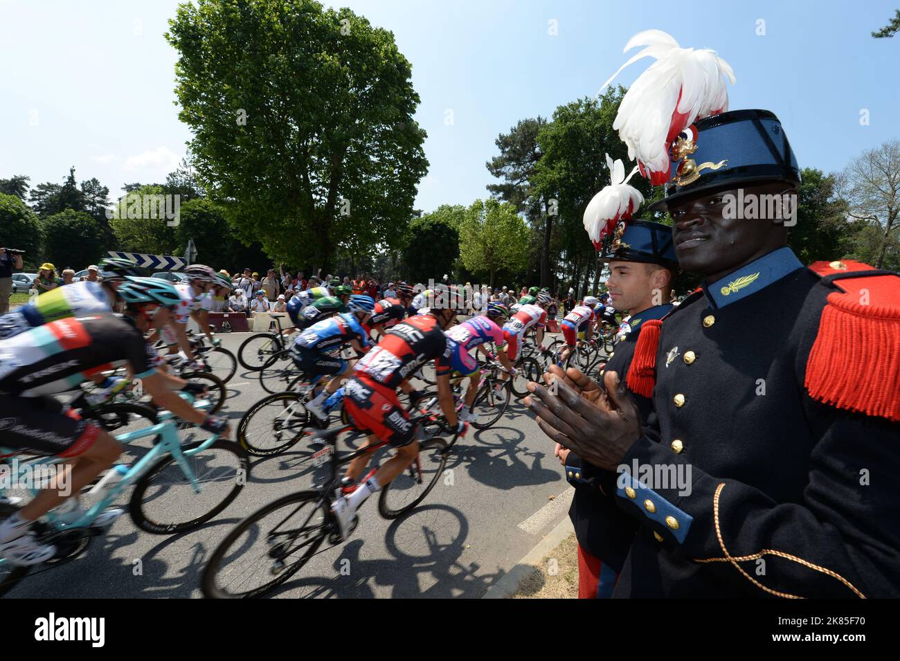 Soldiers from the French army stand and watch as the tour de france ...