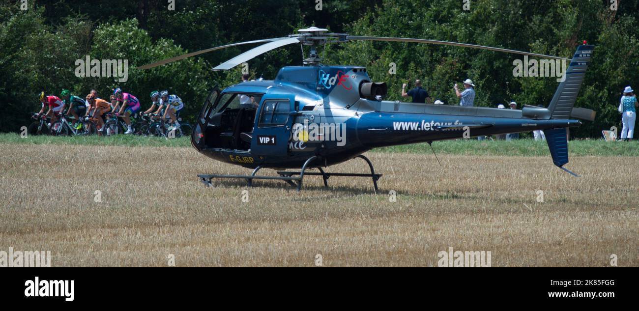 the peloton rides past a Tour de France helicopter for VIPs in the ...