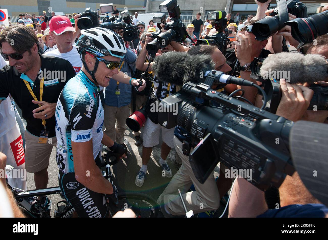 Matteo Trentin is surrounded by the media on the finish line after ...