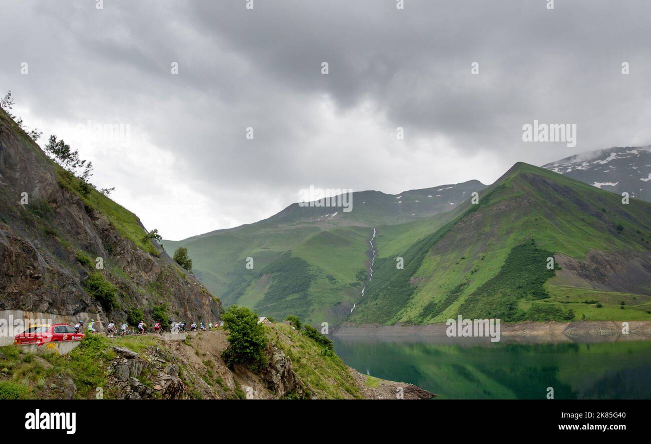 The peloton ride over the first mountain pass the Col du Glandon ...