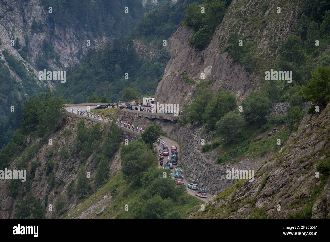 The peloton ride over the first mountain pass the Col du Glandon ...