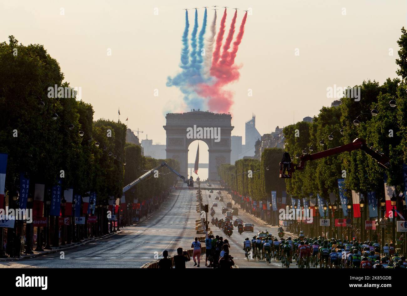 The Peloton arrive on the Champs Elysees for the first lap while the ...