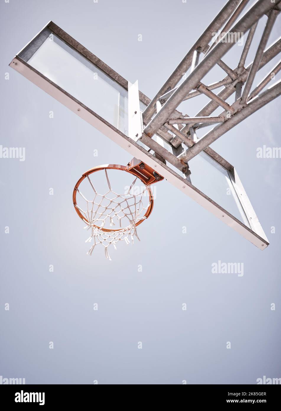 Basketball, sports and net with a hoop on a court on a cloudy day from ...
