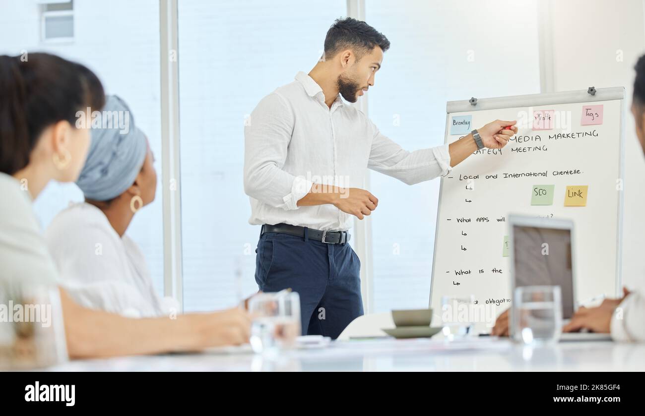 Meetings keep up synchronized. a handsome young businessman giving a ...