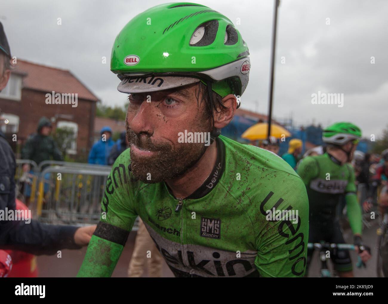 Laurens Ten Dam (Belkin) soaked through and covered in mud as he head ...