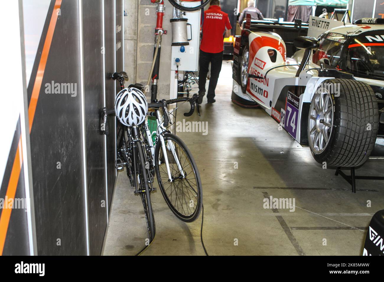 Bikes in the Le Mans pit next to Sir Chris Hoy's Ginetta Nissan LM P3 ...