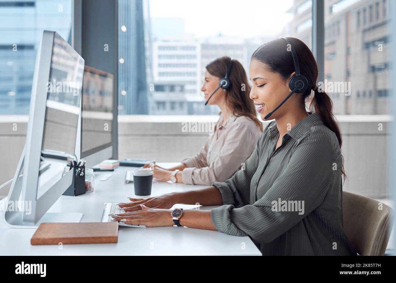 How are you today. two female customer care workers in their office ...