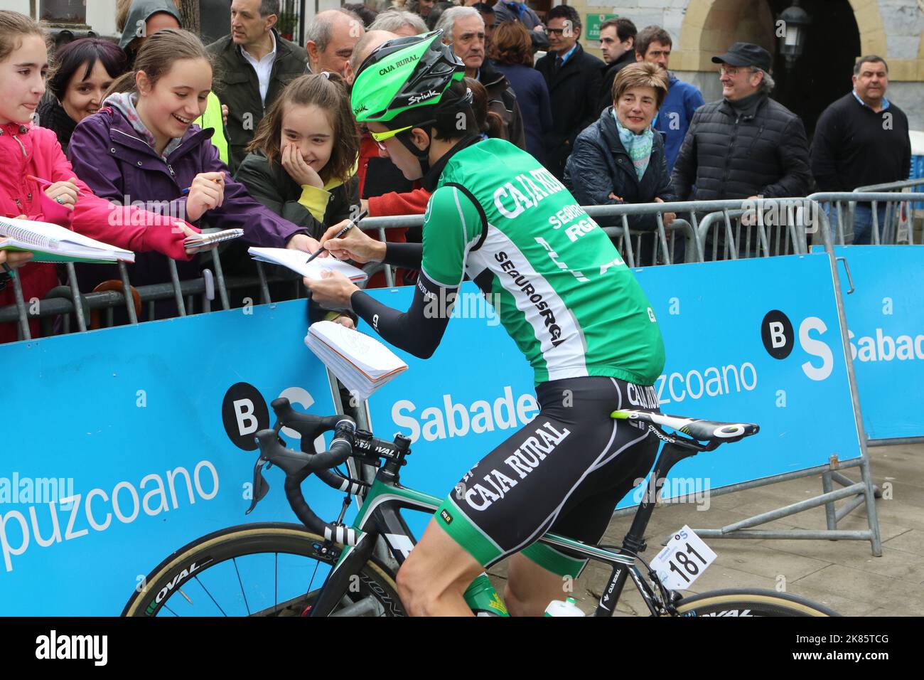 Pello Bilbao of Caja Rural signs autographs for fans at the start of ...